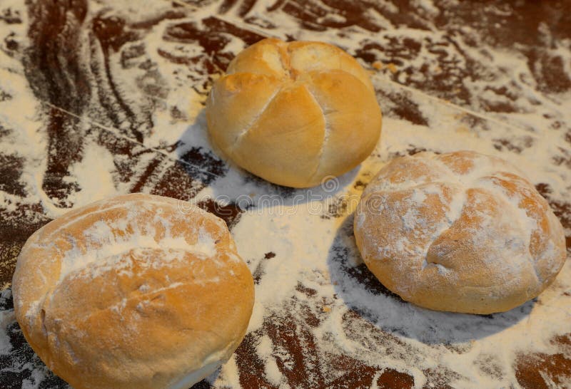 Three Loaves of Freshly Baked Bread with White Flour on the Counter of ...