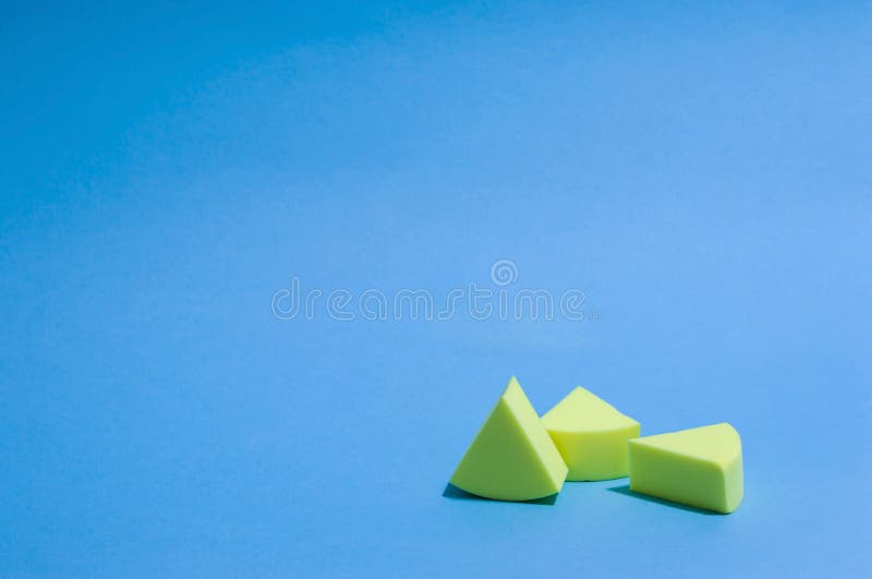 Three Make-up Yellow Sponges on a Blue Background Stock Photo - Image ...