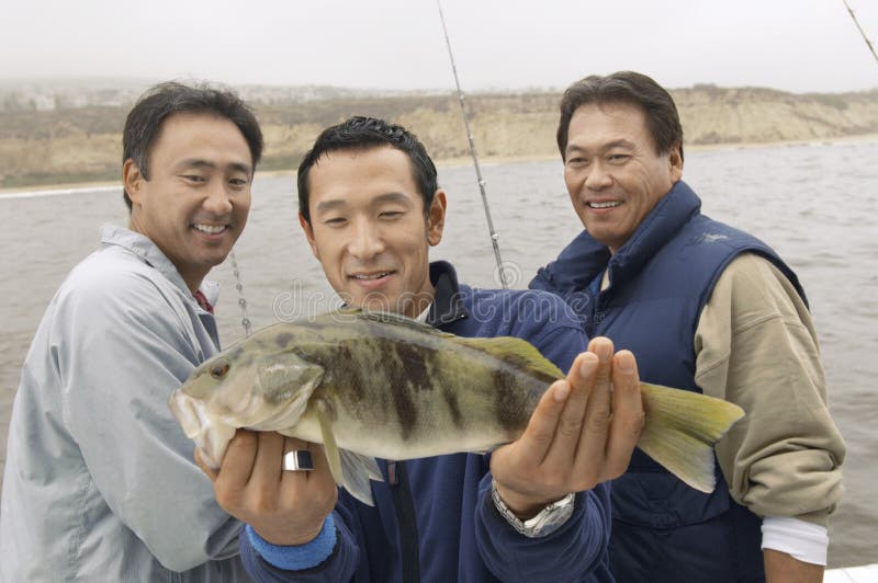 Three Male Friends with a Catch Stock Image - Image of horizontal ...