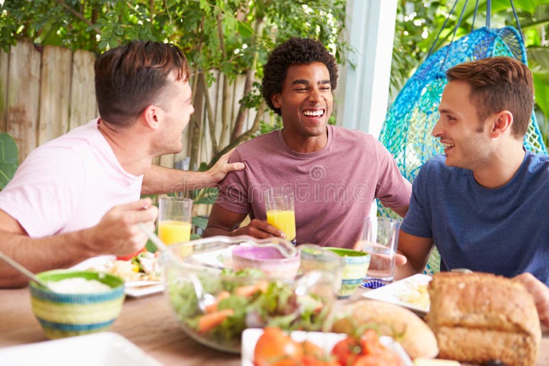 Three Male Friends Enjoying Meal Outdoors at Home Stock Photo - Image ...