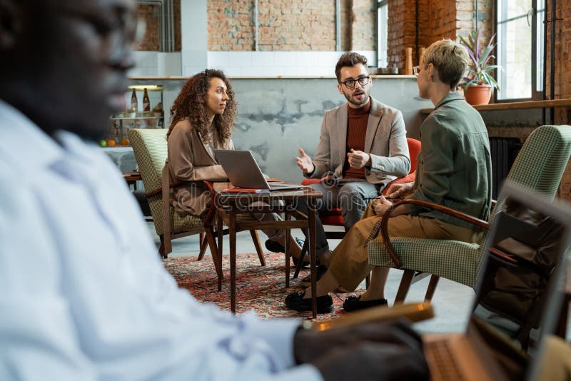 Three Managers Discussing Their Ideas by Table Stock Image - Image of ...