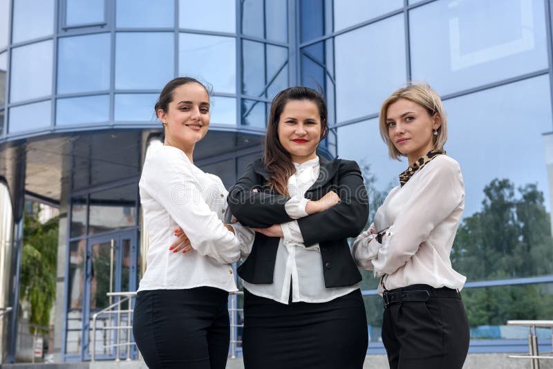 Three Managers with Folders Posing Outside Office Building Stock Photo ...