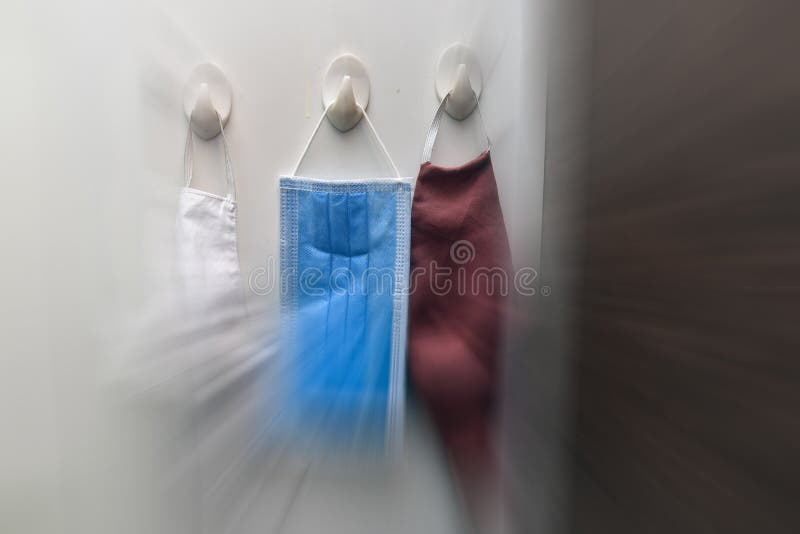 Three Medical Face Mask Hang on a Key Hanger Rack with Motion Blur ...