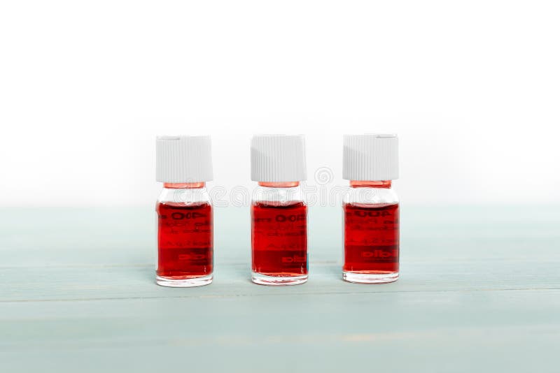 Three Medicine Vials Filled with Red Liquid Stock Photo - Image of ...