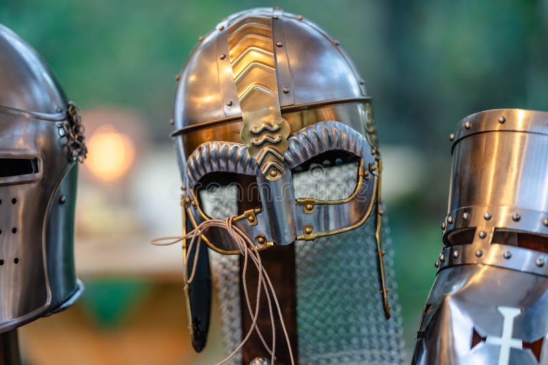 Three Medieval Helmets are Displayed, One of Which Has a Mask on it ...