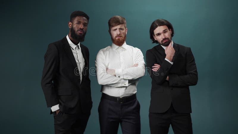Three Men Friends are Posing and Looking at the Camera Seriously Stock ...