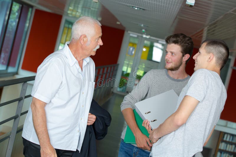 Three Men Having Conversation on Hallway Stock Image - Image of casual ...