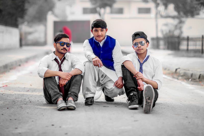 Three Men Sitting on Gray Concrete Road Stock Image - Image of product ...