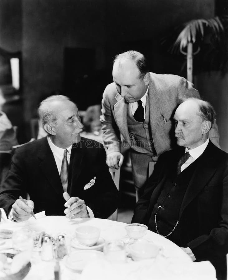 Three Men Sitting at the Counter of a Diner Stock Photo - Image of ...