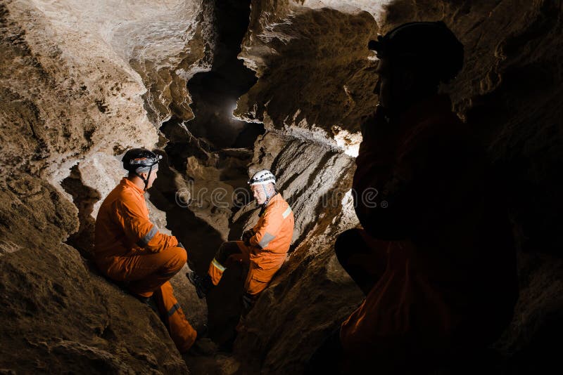 Three Men, Strong Physique, Explore the Cave. Men Dressed in Special ...