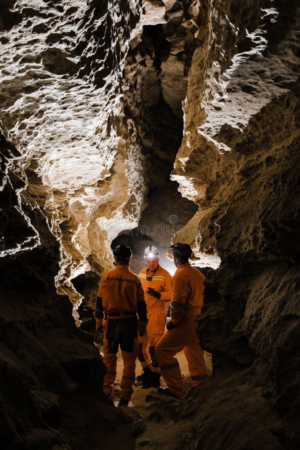 Three Men, Strong Physique, Explore the Cave. Men Dressed in Special ...