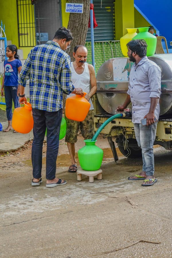 Three Men Take Drinking Water from a Mobile Water Tank in Puttaparthi ...