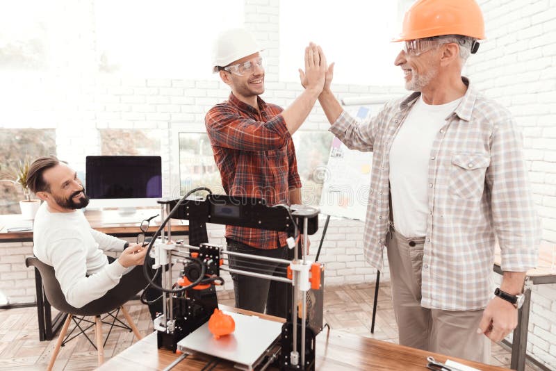 Three Men are Working To Prepare Printed on a 3d Model Printer. they ...