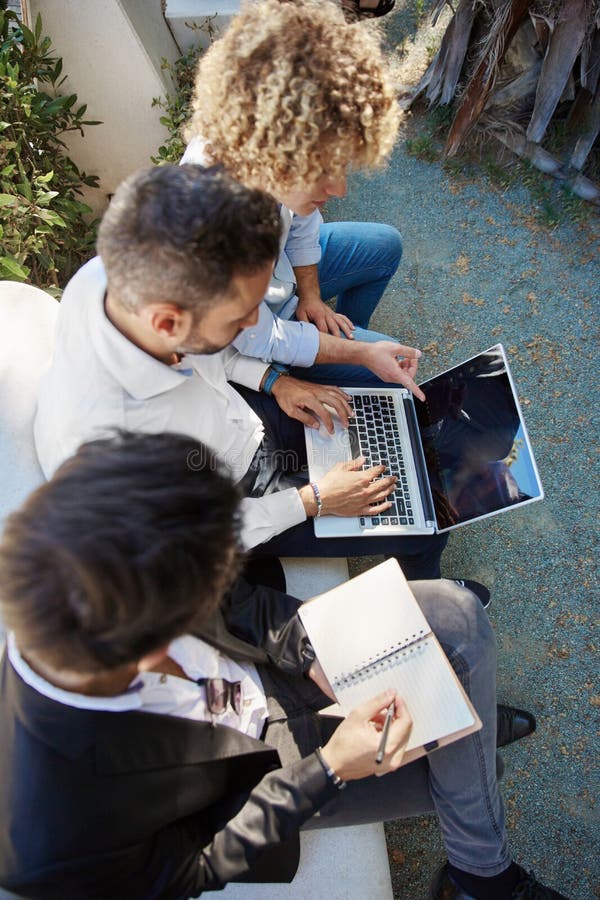 Three Men Working Together on Laptop Outside Stock Image - Image of ...