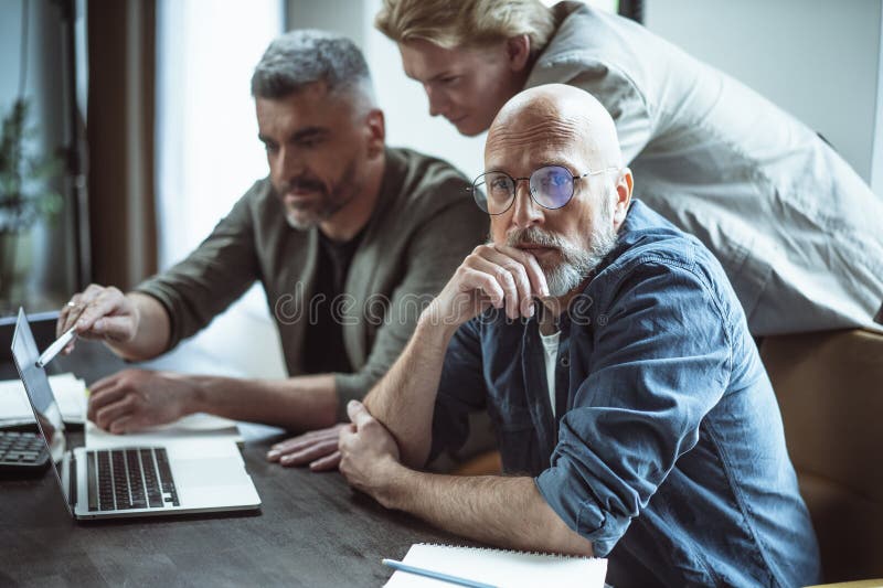 Three Men Working Together on Laptops Stock Image - Image of three ...