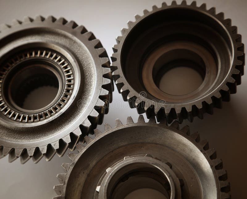 Three metal cogs stock photo. Image of three, indoors - 374186838