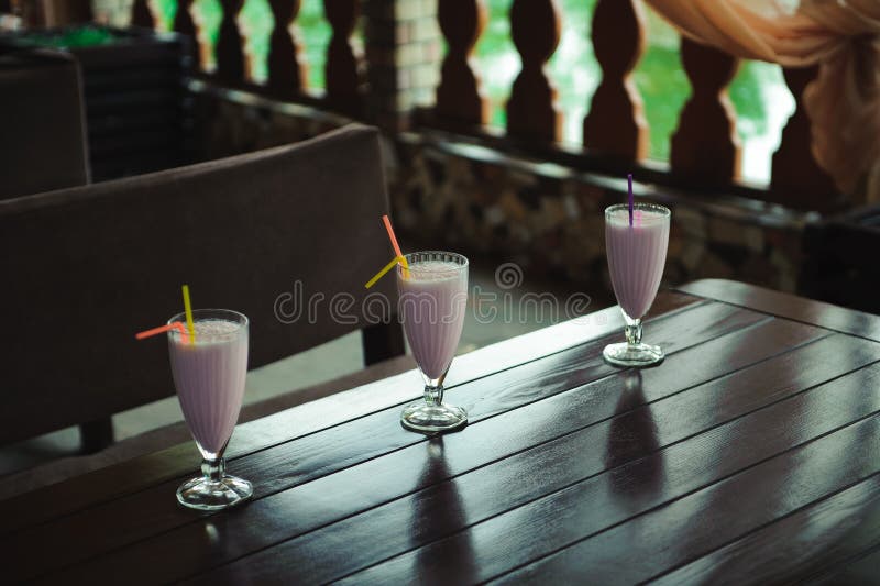 Three Milkshakes and Smoothies on Wooden Table Stock Photo - Image of ...