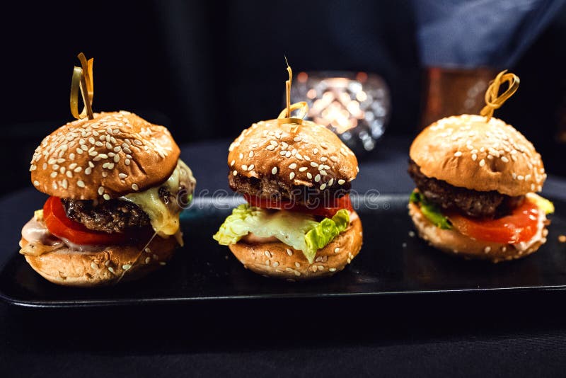 Three Mini Burgers on a Black Rectangular Elongated Stand. Stock Photo ...