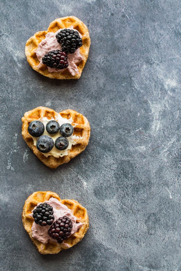 Three Mini Heart Shaped Waffles with Cream Cheese Spread and Berries on ...