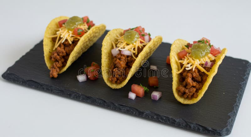 Three Mini Tacos with Ground Beef Salsa and Cheese on Dark Slate Stock ...
