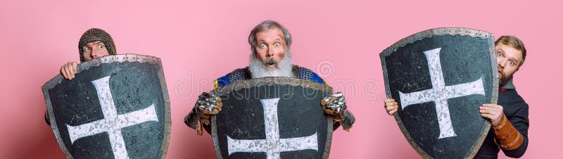 Three Mix-aged Men, Medieval Warriors in Armor Hiding Themselves Behind ...