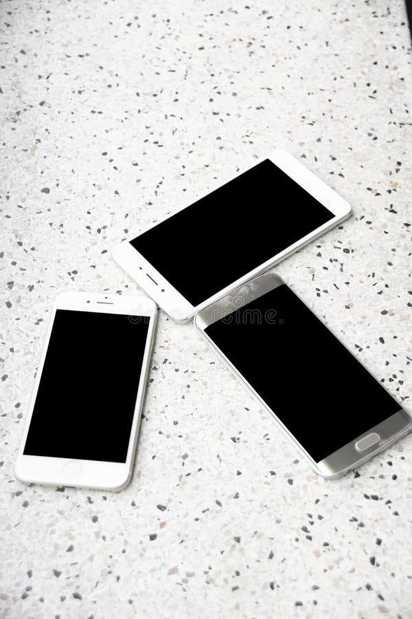 Three Mobile Phones are Placed on the Marble Floor Stock Image - Image ...