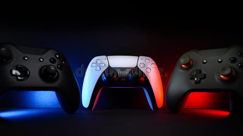 Three Modern Gamepads Illuminated by Red and Blue Light Stock Image ...