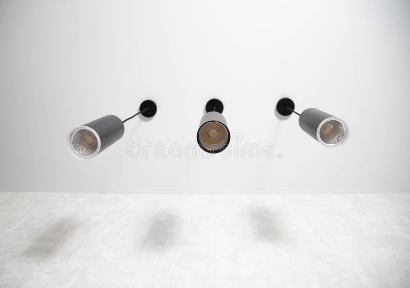 Three Modern LED Lights Hang from the Ceiling on a Wire Stock Photo ...