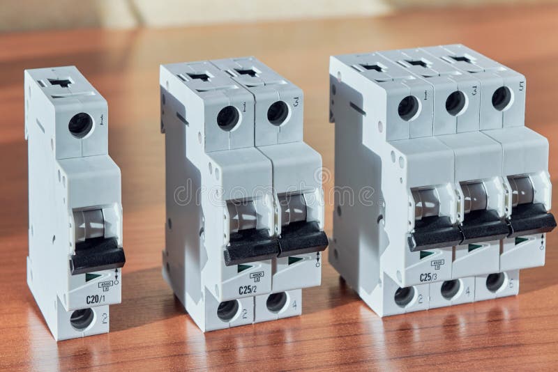Three Modular Electrical Circuit Breakers Lie on the Table. Stock Photo ...