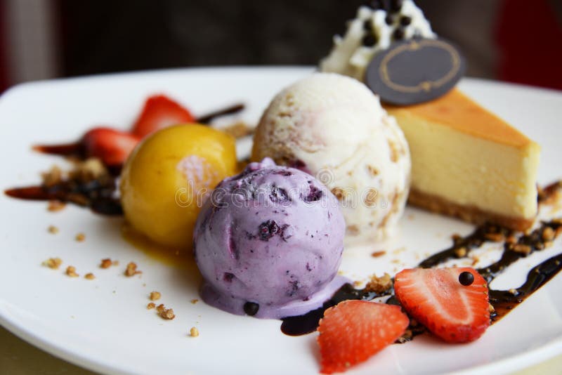 Three Multi-colored Balls of Ice Cream and Cheesecake Stock Image ...