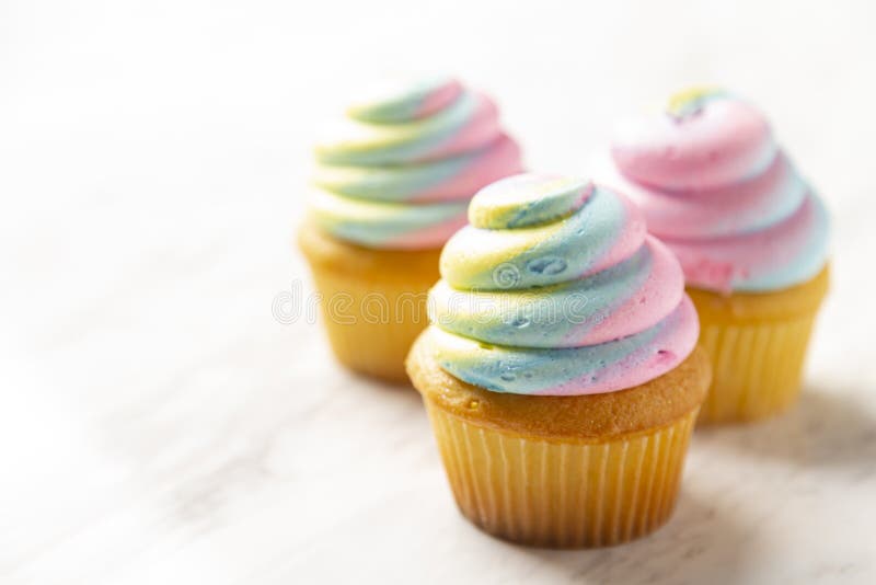 Three Multi Colored Cupcakes Stock Photo - Image of desert, pink: 172929454
