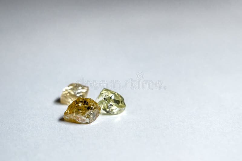 Three Multi-colored Diamonds Lie on a White Plastic Surface Stock Photo ...
