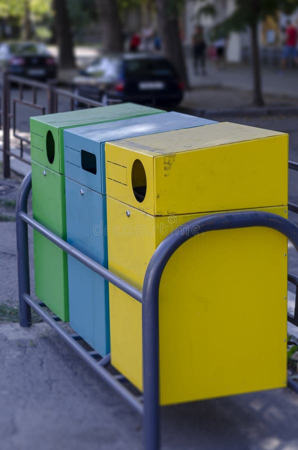 Three Multi-colored Garbage Containers on a City Street Stock Image ...
