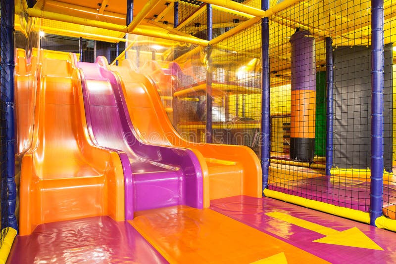 Three Multi-colored Plastic Slides in the Children`s Play Complex ...
