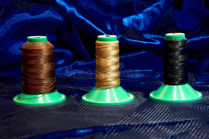Three Multi-colored Spools of Thread Stock Photo - Image of brown ...