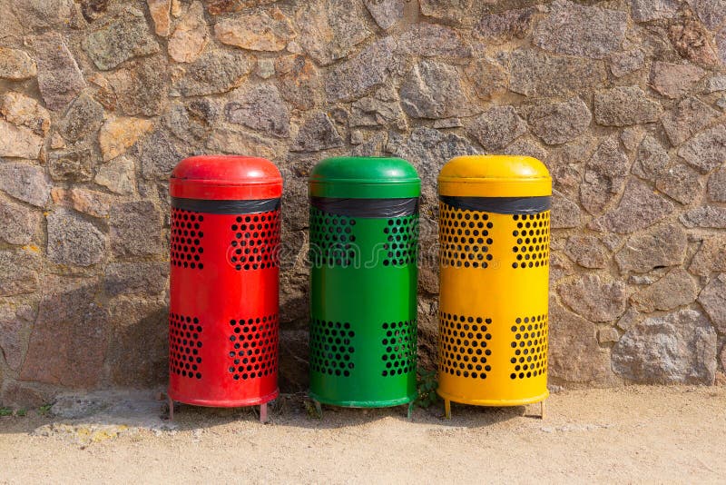 Three Multicolored Recycle Bins for Waste Near the Wall. Sort Waste ... Three Multicolored Recycle Bins for Waste Near the Wall. Sort Waste ...