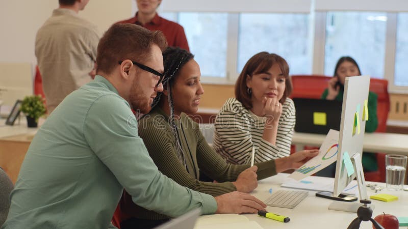 Three Multiethnic Colleagues Employees Cooperating in Office Talking ...