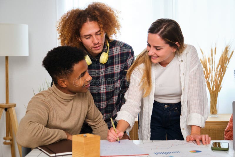 Three Multiethnic College Students Studying Together at Home. Stock ...