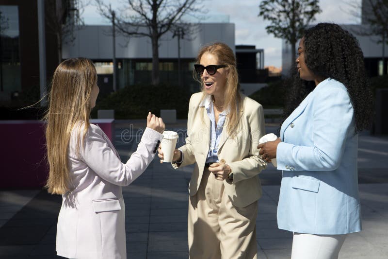Three Multiethnic Women of Different Ages Stroll while Having a Coffee ...
