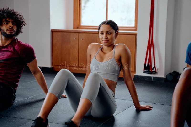 Three Multiracial Young Adults Taking a Break at the Gym Stock Photo ...
