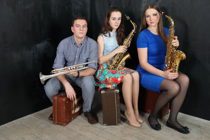Three Musicians with Wind Instruments in Their Stock Image - Image of ...