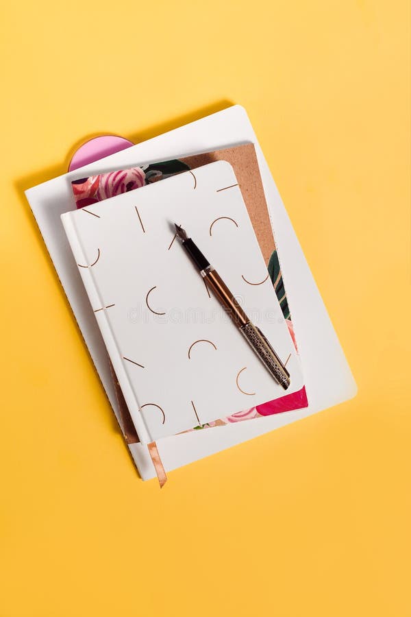 Three Notebooks on Yellow Background with Ink Pen and Copy Spaces ...