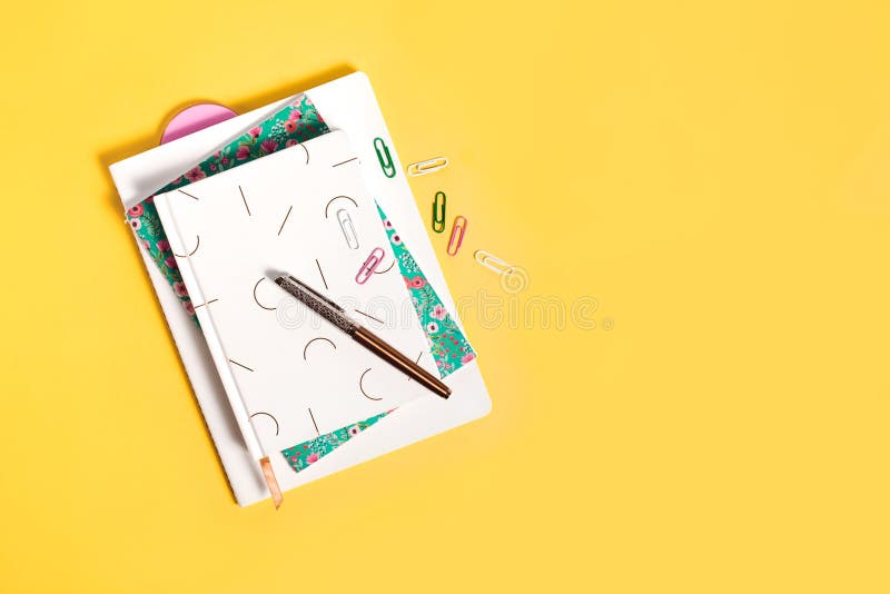 Three Notebooks on Yellow Background with Ink Pen and Copy Spaces ...