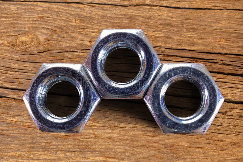 Three Nuts Lie on a Background of Old Wood Stock Photo - Image of build ...