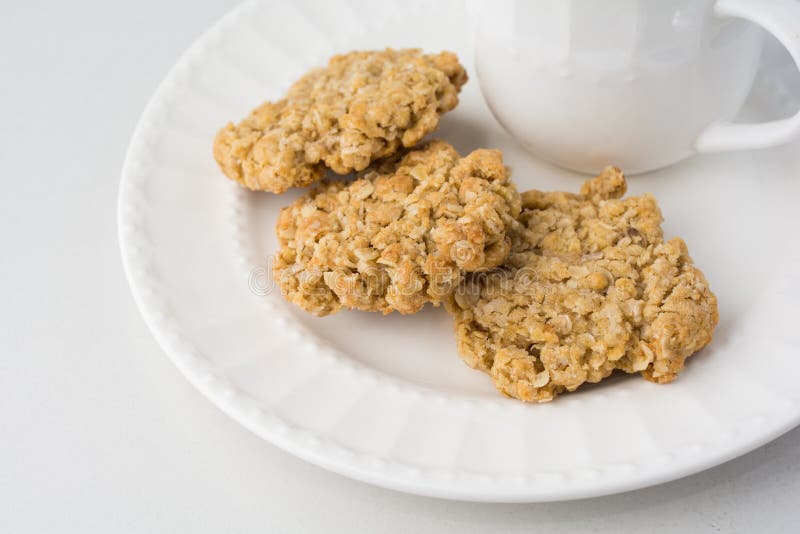 Three Oatmeal Cookies on White Plate with Teacup Stock Image - Image of ...