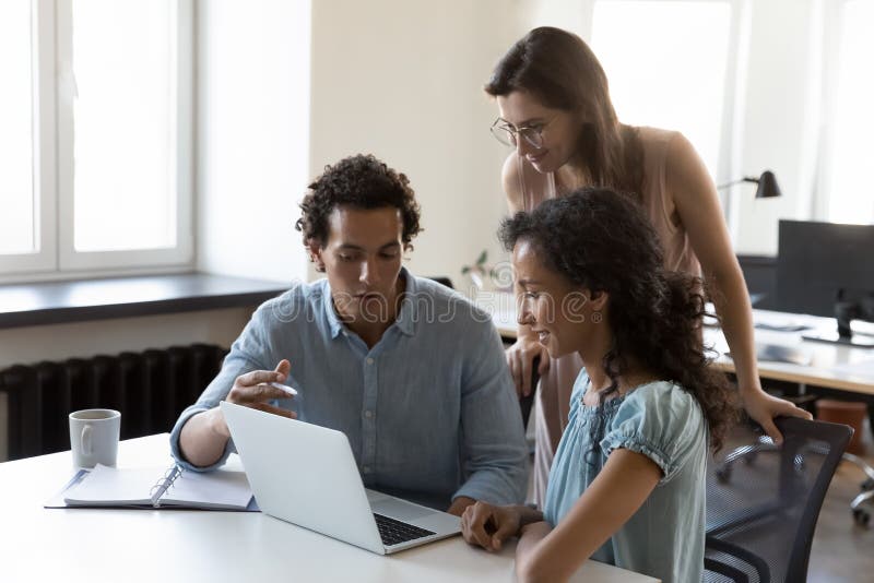 Three Office Employees Discussing Strategy, Working on Project Using ...
