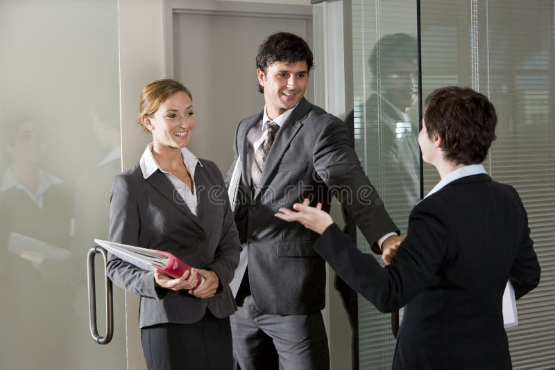 Three Office Workers Chatting at Door of Boardroom Stock Photo - Image ...