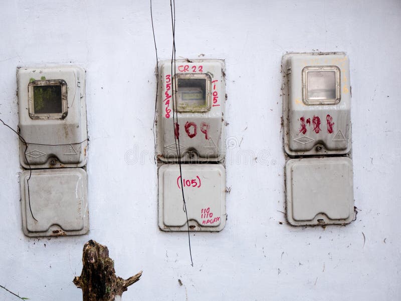 Three Old Electrical Meters Installed on a White Wall Stock Image ...