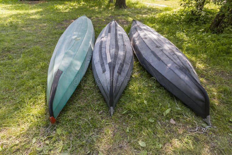 Three Old Kayaks Lying on Grass Stock Image - Image of canoe, grass ...