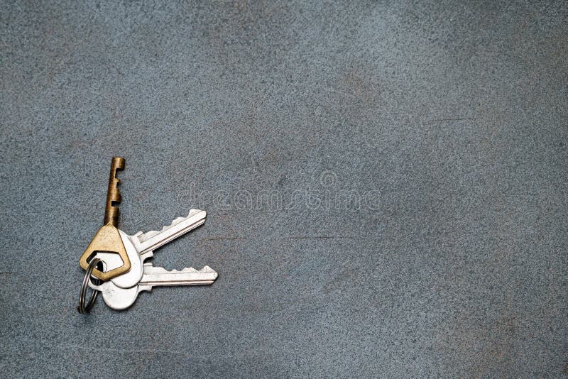 Three Old Keys on a Ring on an Abstract Gray Background. View from ...